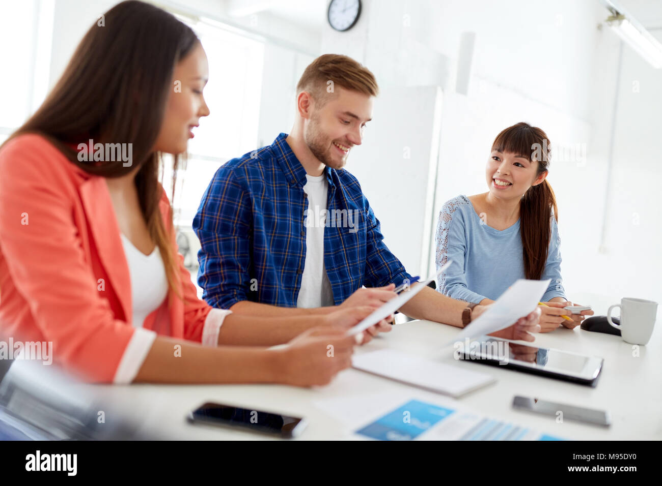 Happy creative team papers hi-res stock photography and images - Alamy