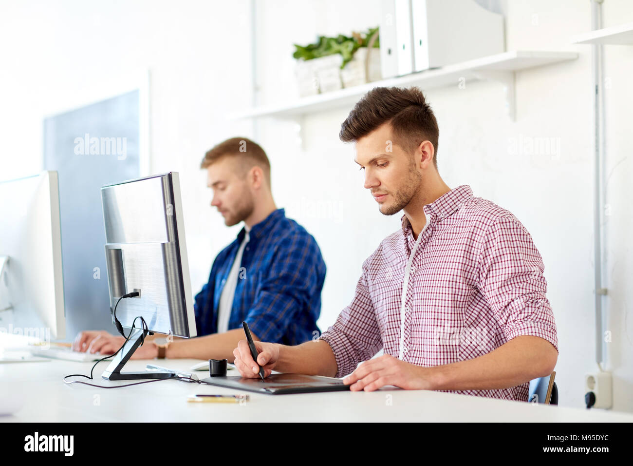 designer with computer and pen tablet at office Stock Photo - Alamy