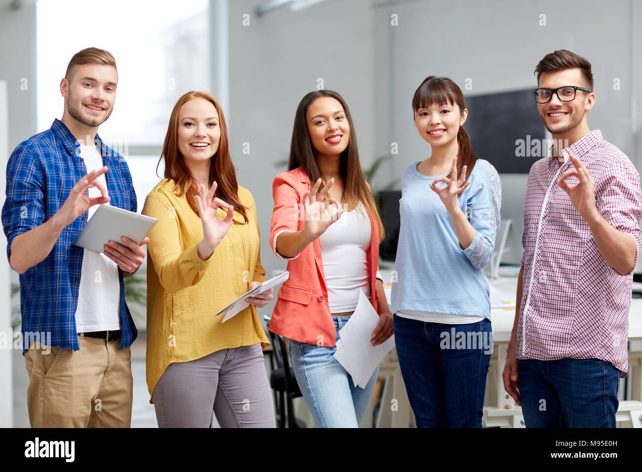 happy creative team showing ok hand sign at office Stock Photo - Alamy