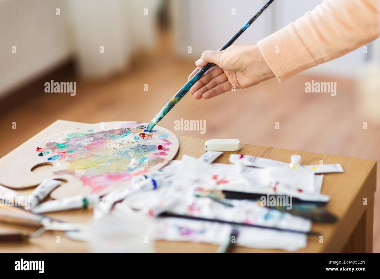 artist hand with paintbrush and color palette Stock Photo - Alamy