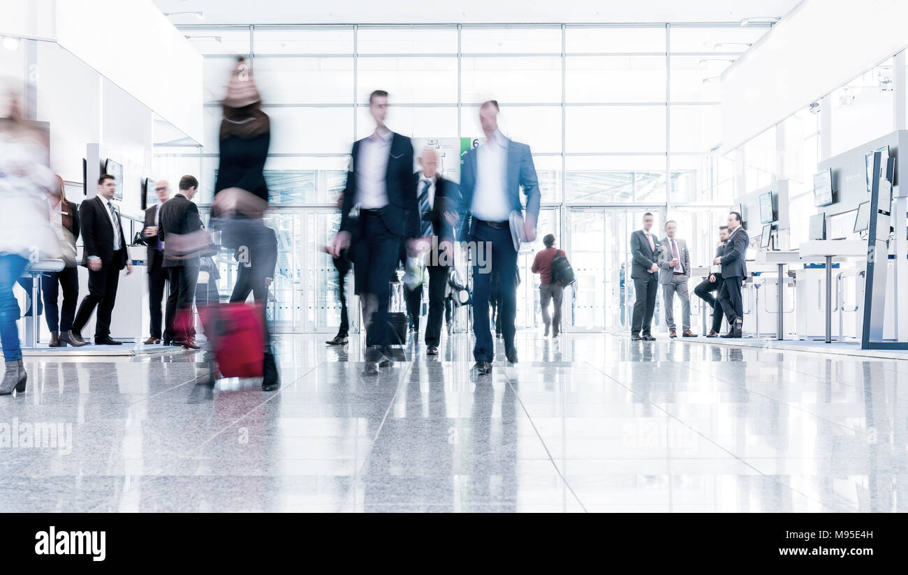 blurred people at a trade fair hall Stock Photo - Alamy