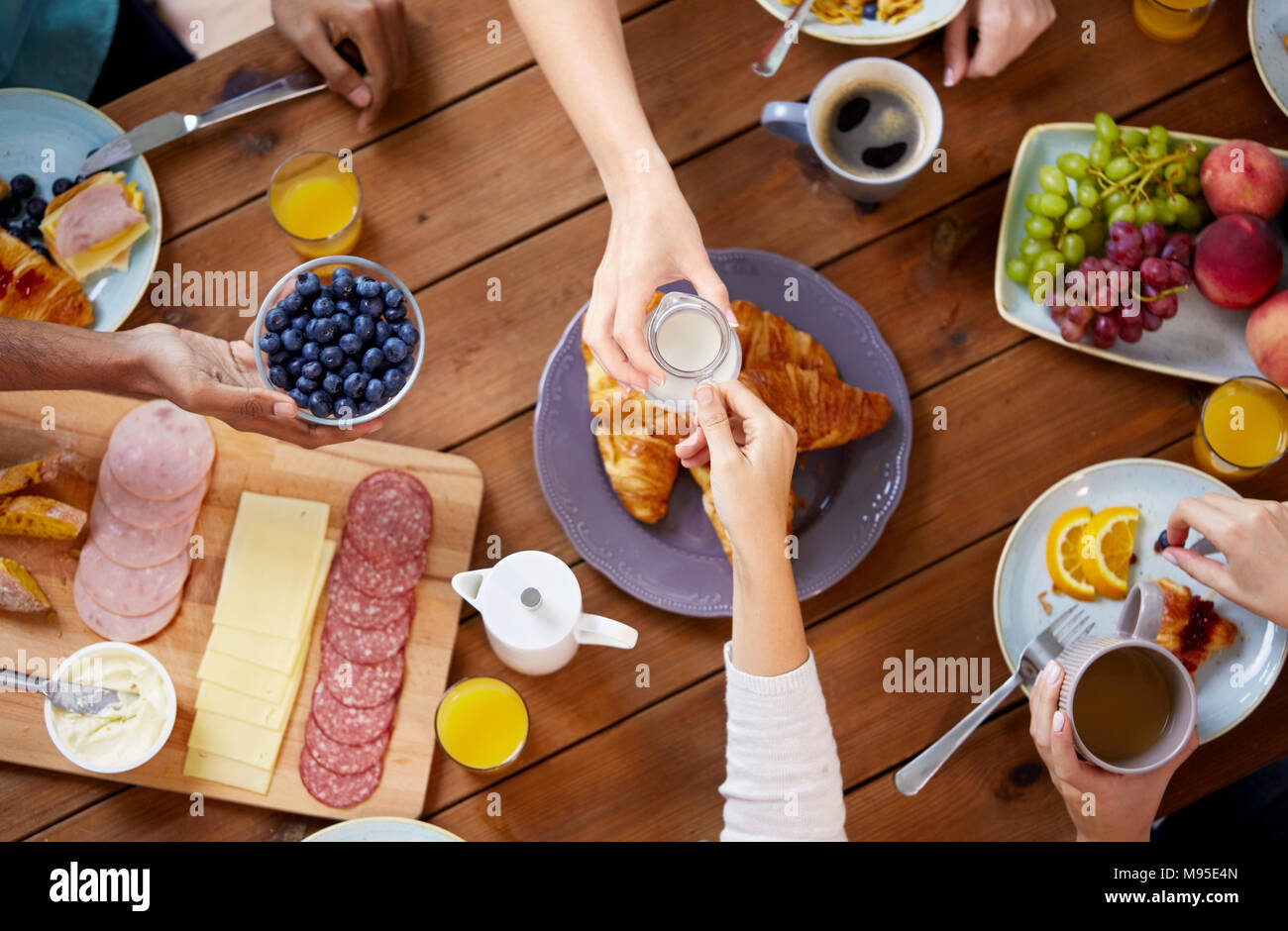 people having breakfast at table with food Stock Photo - Alamy