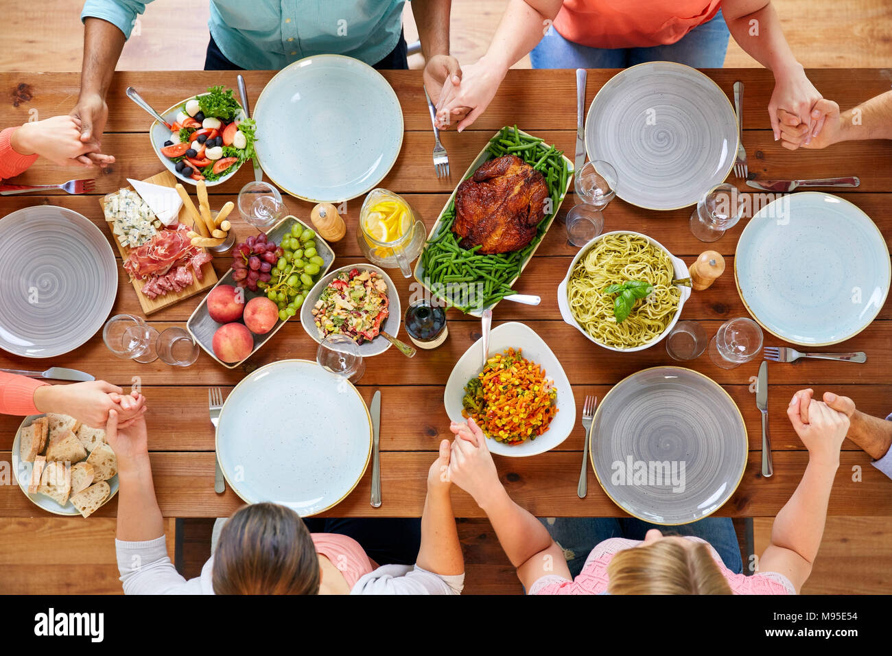 group of people at table praying before meal Stock Photo - Alamy