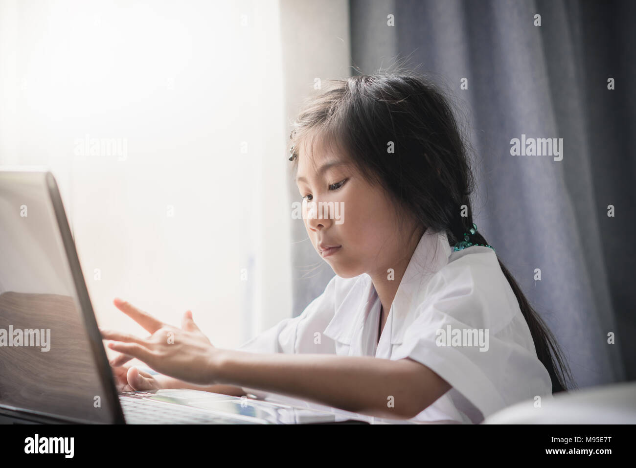 Girl Using Laptop at home Stock Photo - Alamy