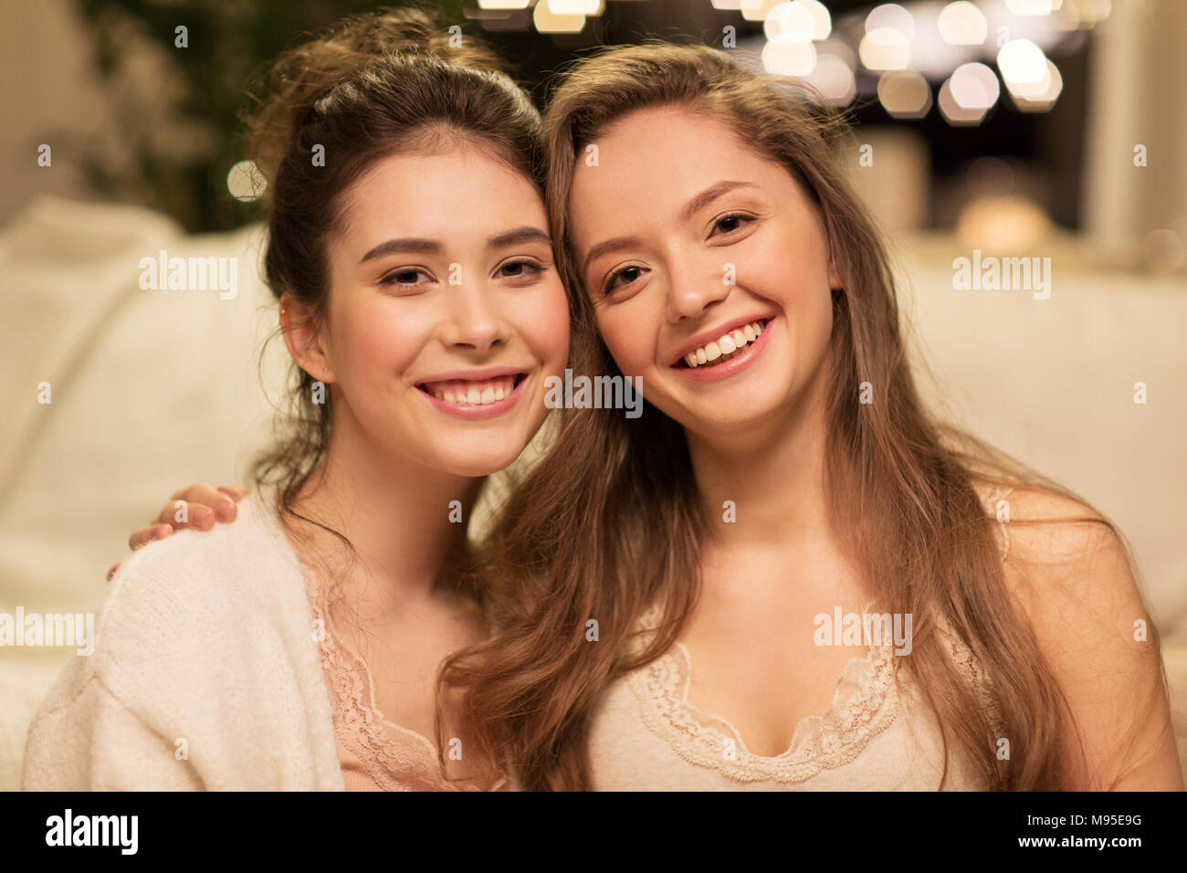 happy female friends hugging Stock Photo - Alamy