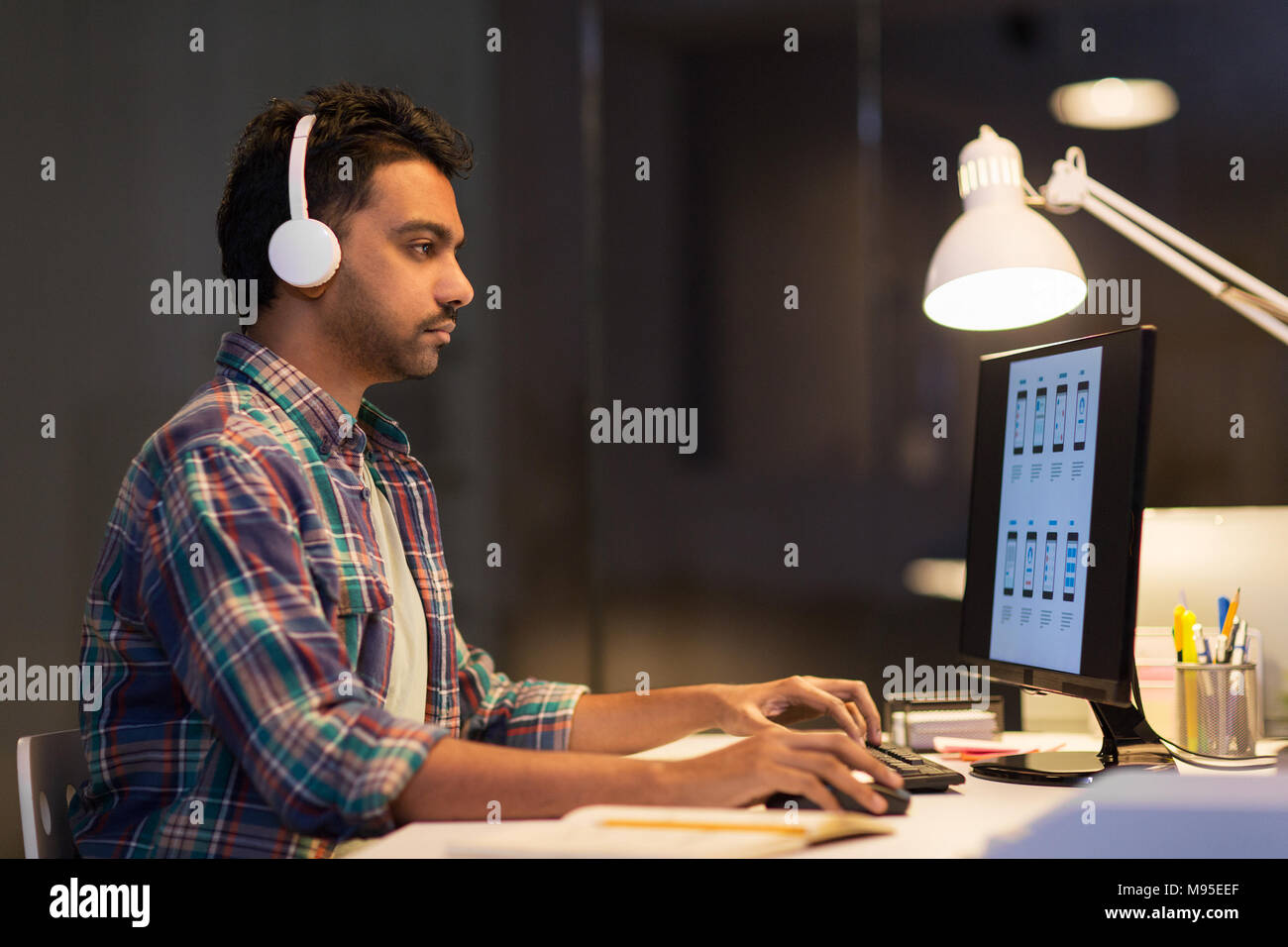 creative man in headphones with computer at office Stock Photo - Alamy