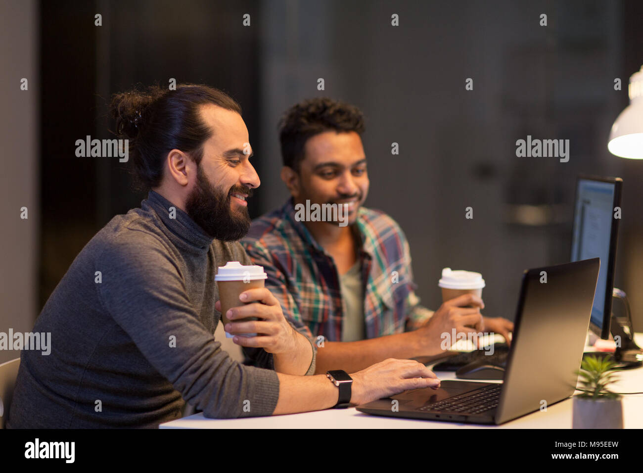 creative team drinking coffee at night office Stock Photo - Alamy