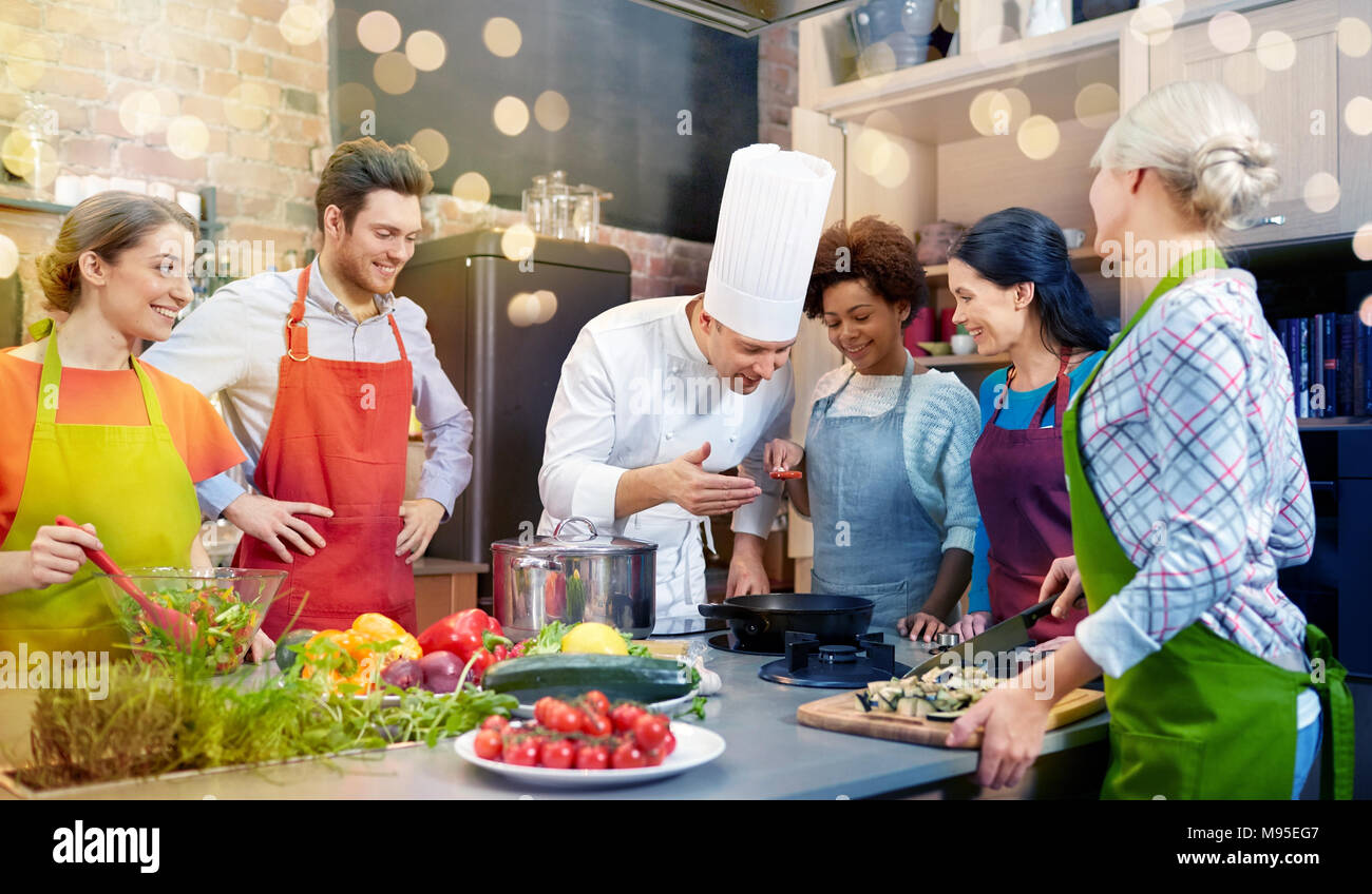 happy friends and chef cook cooking in kitchen Stock Photo - Alamy