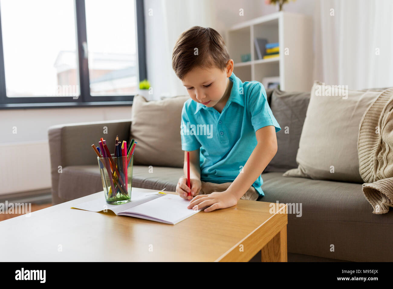 boy with notebook and pencils drawing at home Stock Photo - Alamy
