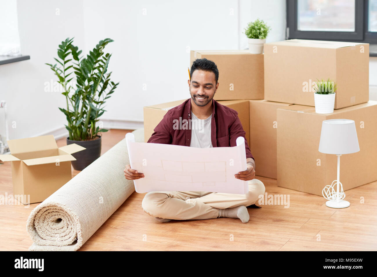 man with boxes and blueprint moving to new home Stock Photo - Alamy