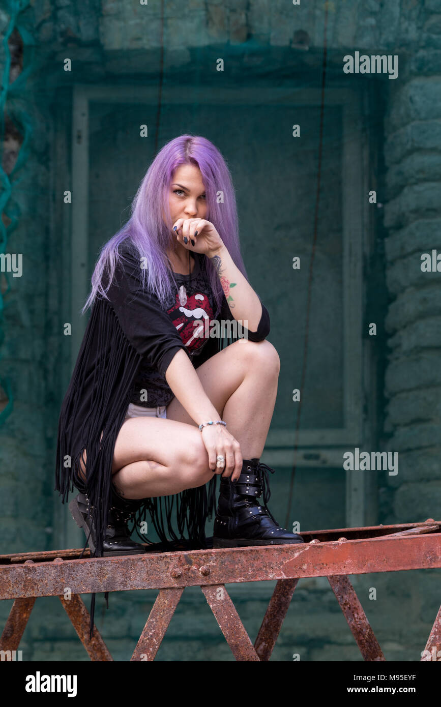 Caucasian white female model and brick stone in the city, modern ...