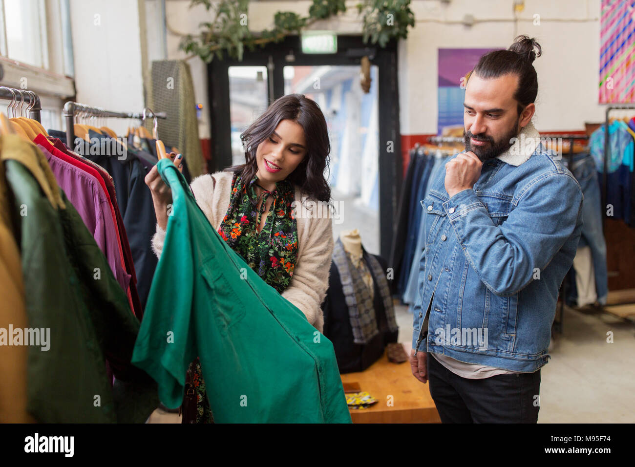 couple choosing clothes at vintage clothing store Stock Photo - Alamy