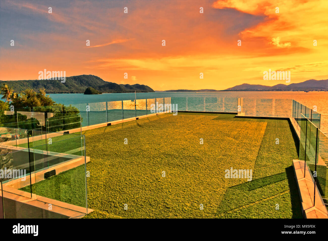 Luxurious terrace overlooking a tropical ocean sunset Stock Photo - Alamy