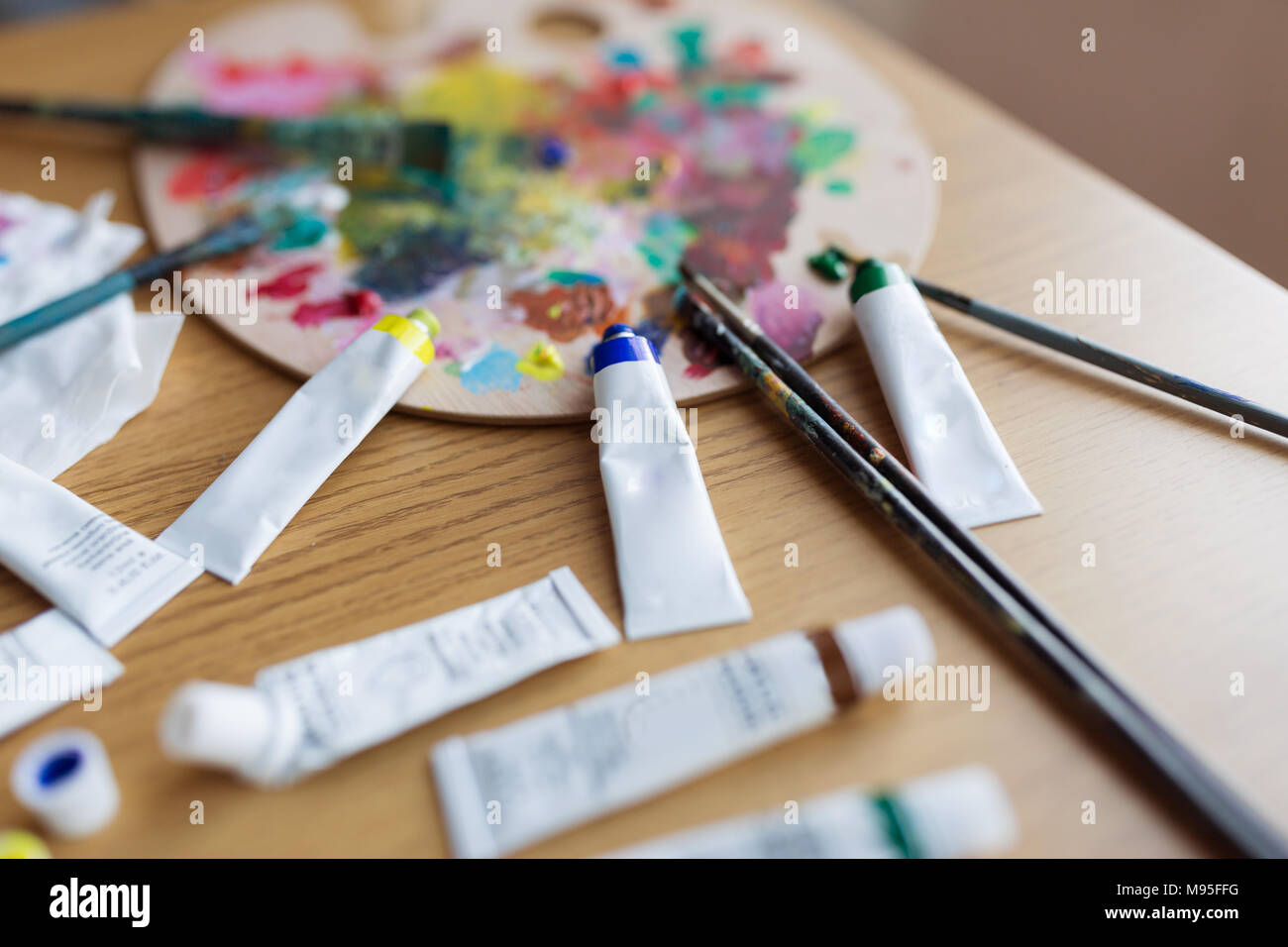 palette, brushes and paint tubes on table Stock Photo - Alamy