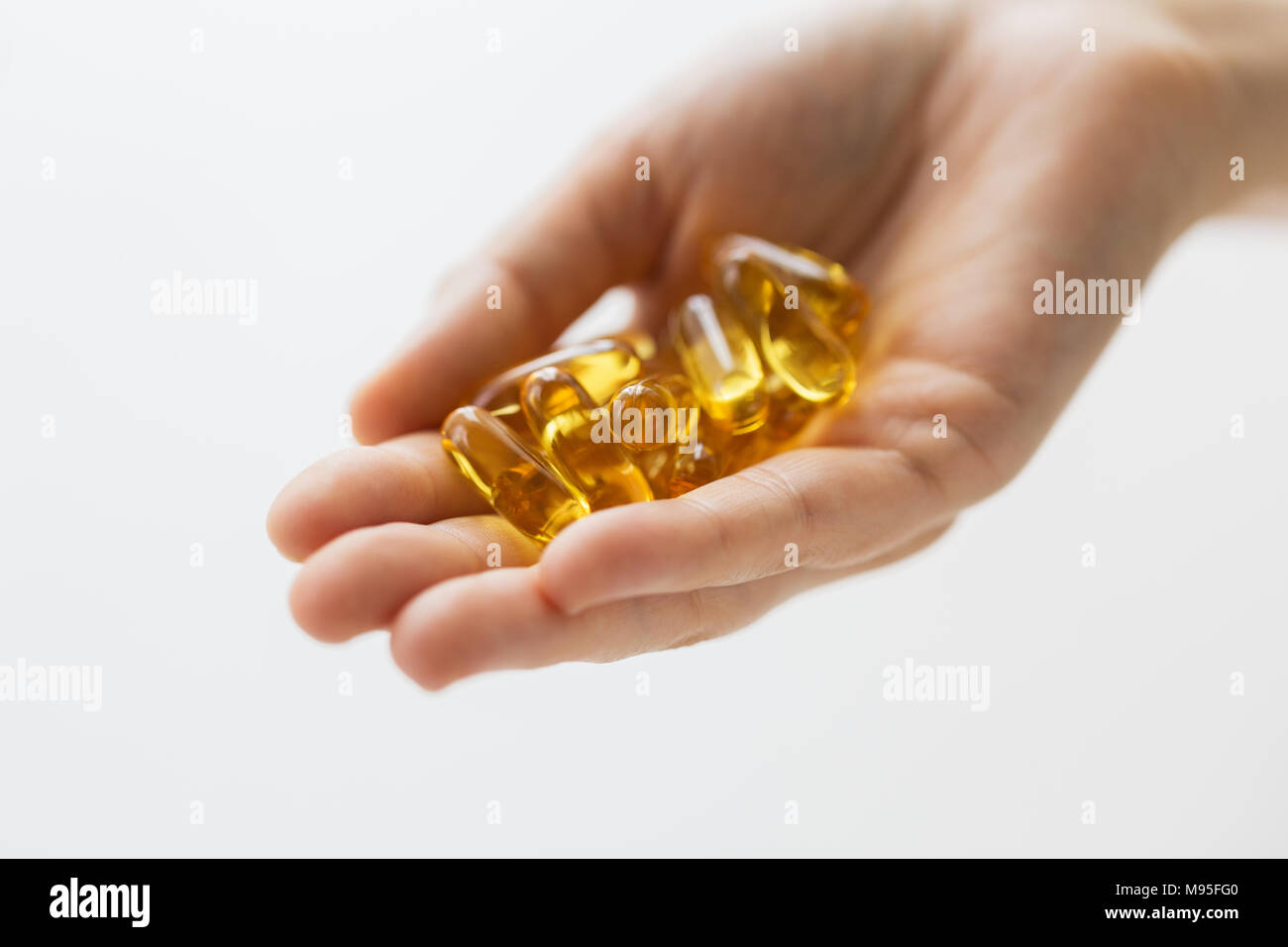 Cod liver oil capsules hand hi-res stock photography and images - Alamy