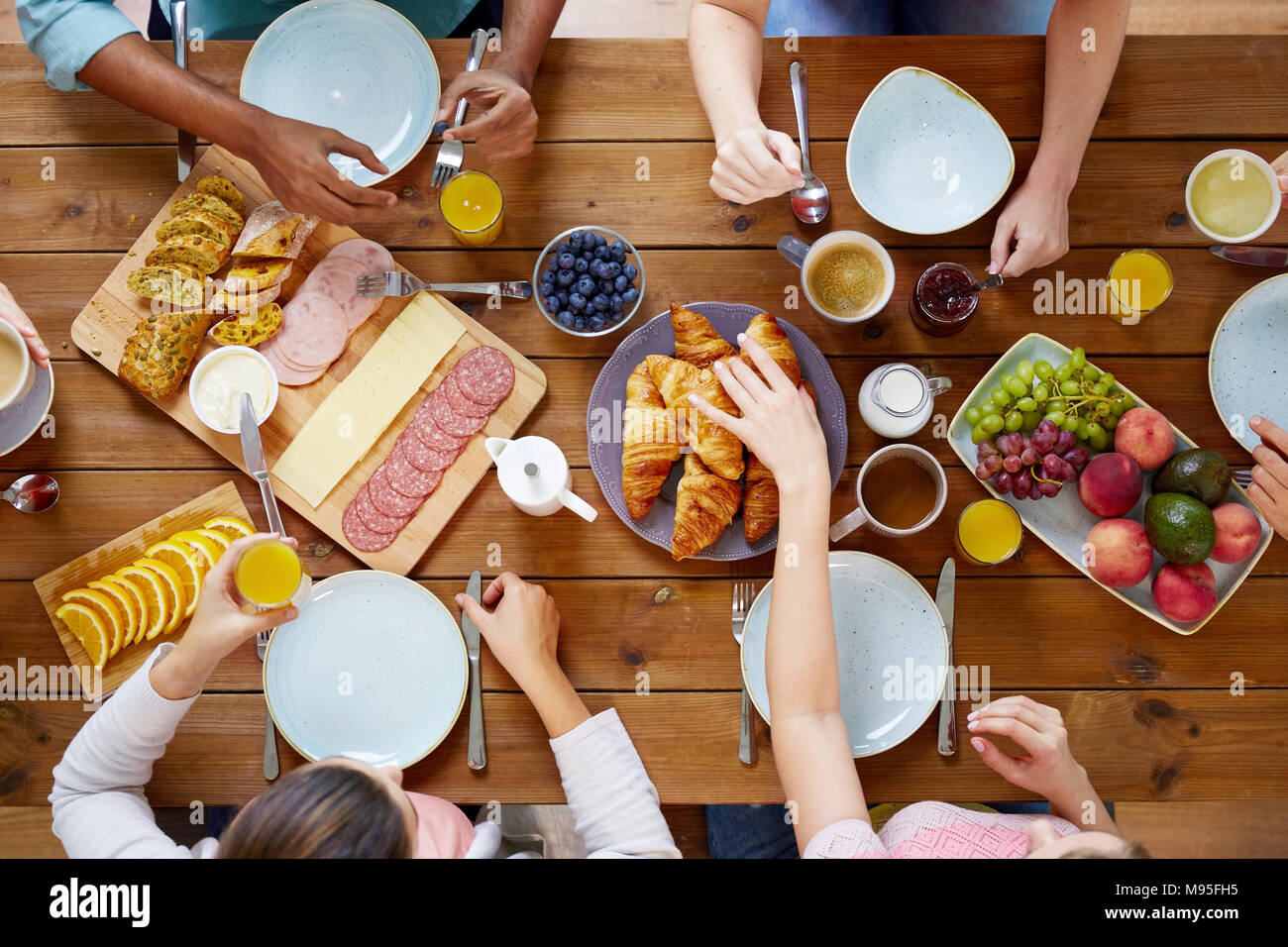 group of people having breakfast at table Stock Photo - Alamy