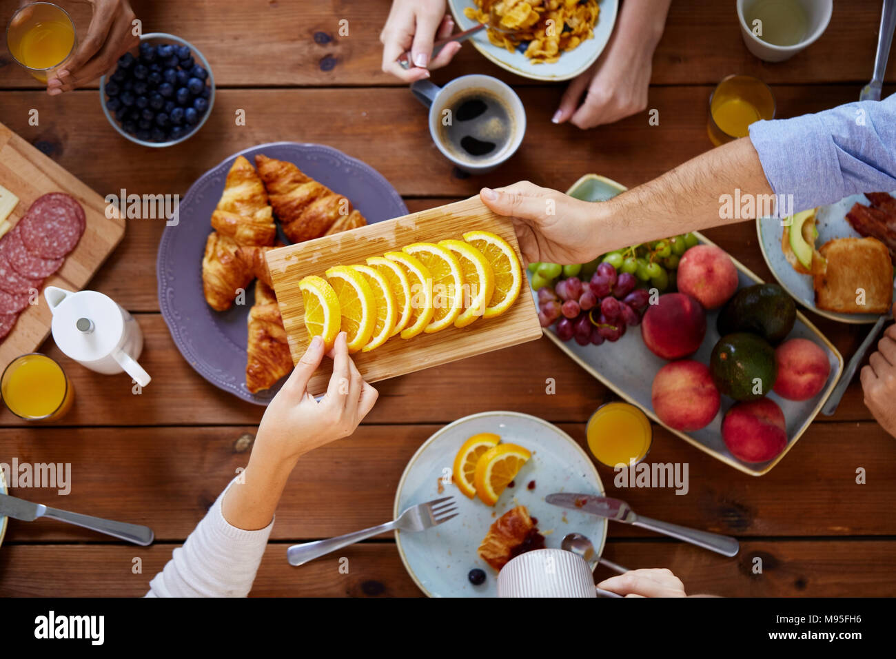 group of people having breakfast at table Stock Photo - Alamy