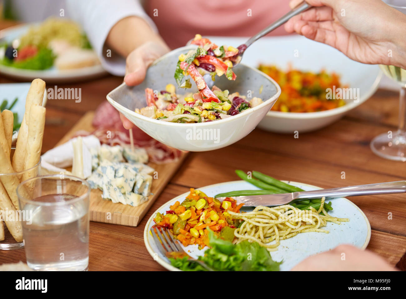 People sharing meal wooden dining hi-res stock photography and images ...