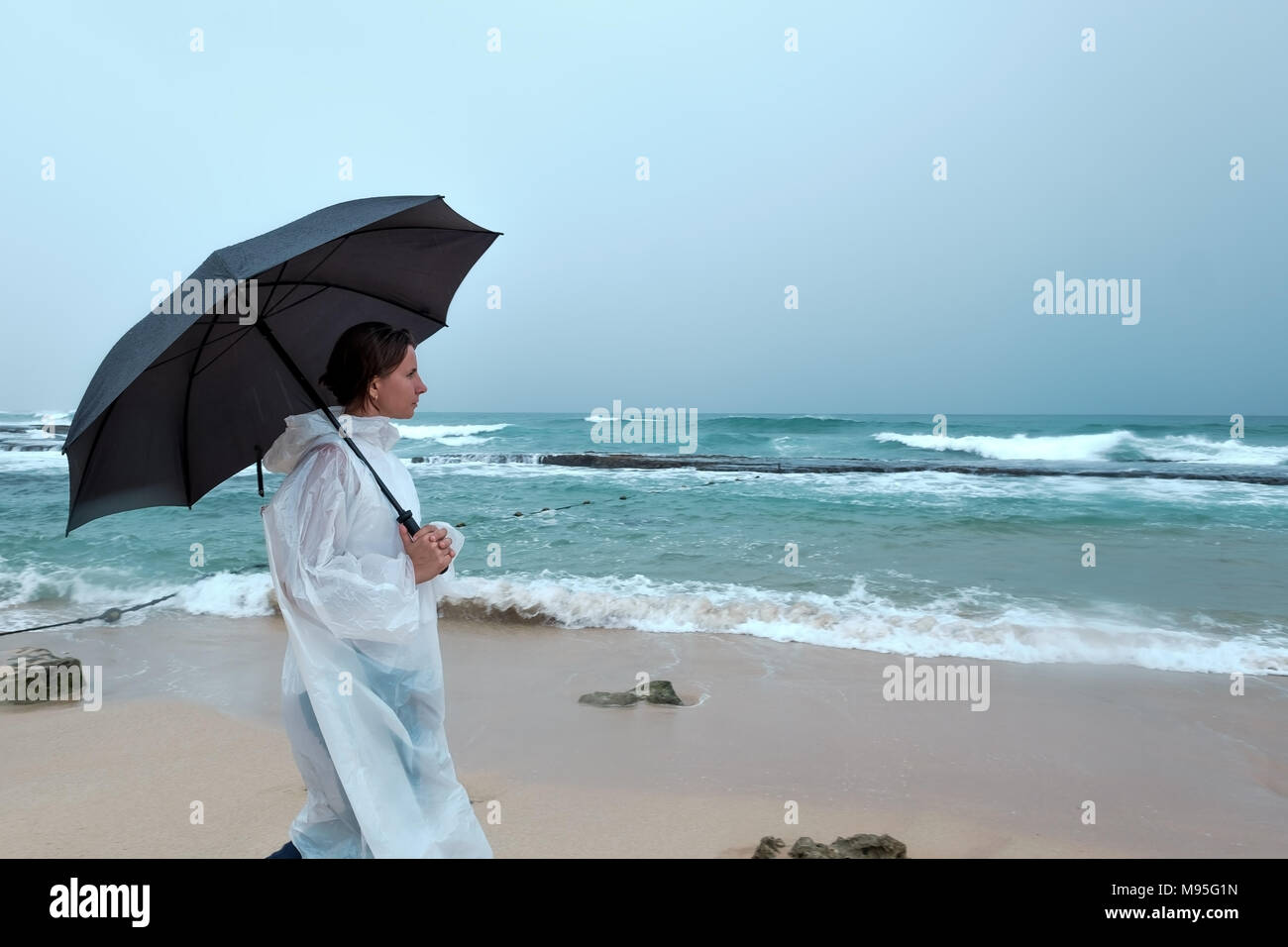 Woman beach umbrella rain hi-res stock photography and images - Alamy