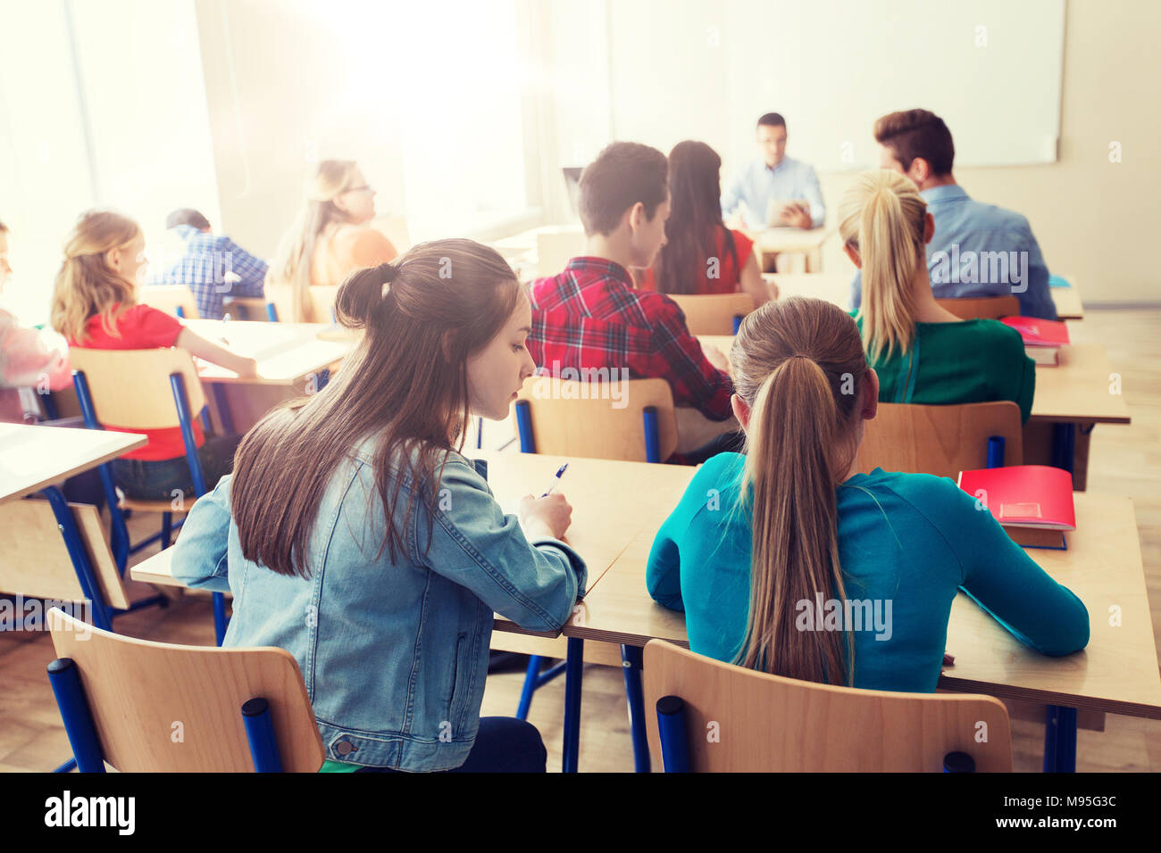 group of students writing school test Stock Photo - Alamy