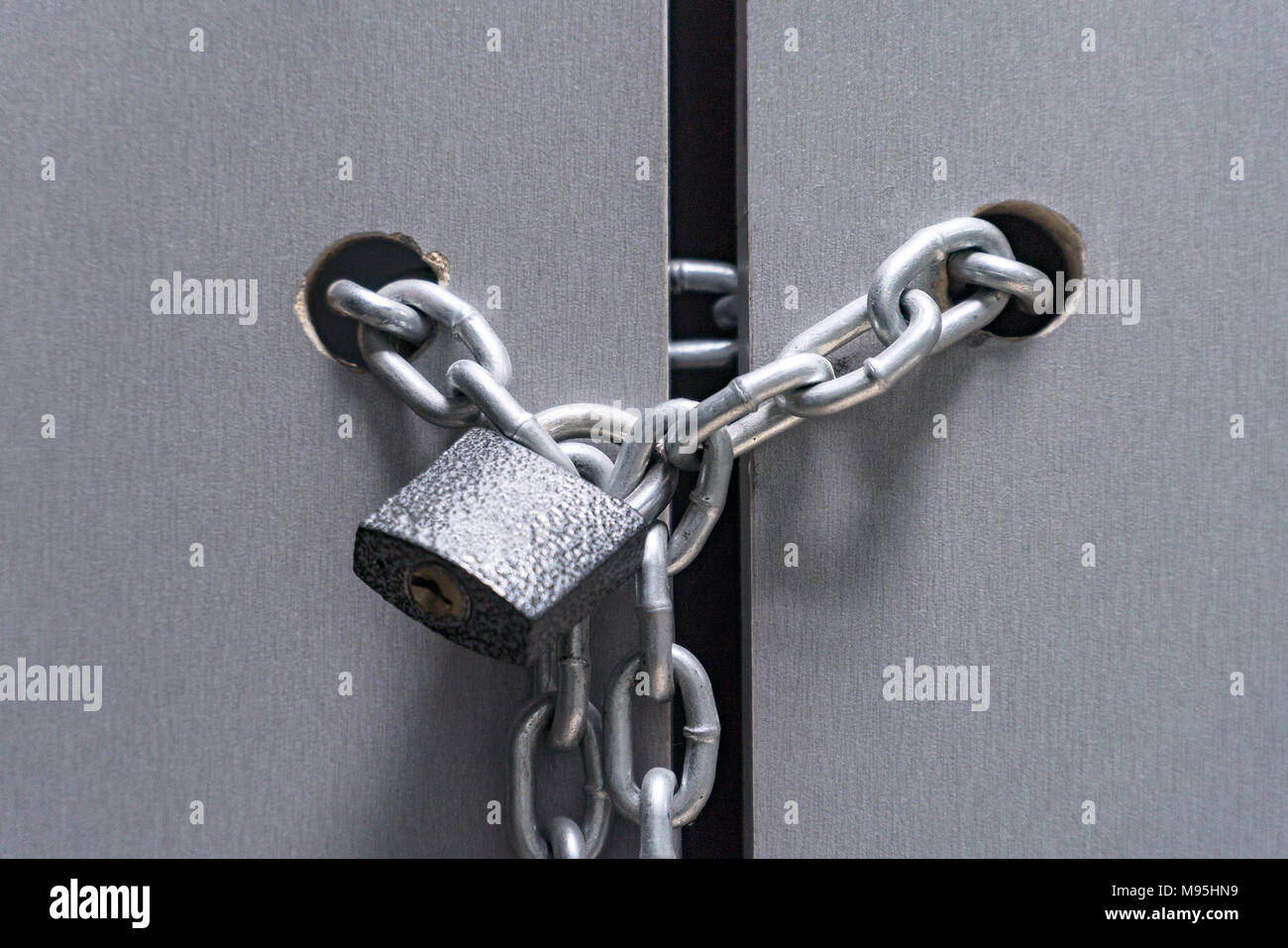 Lock with a chain on the door Stock Photo - Alamy