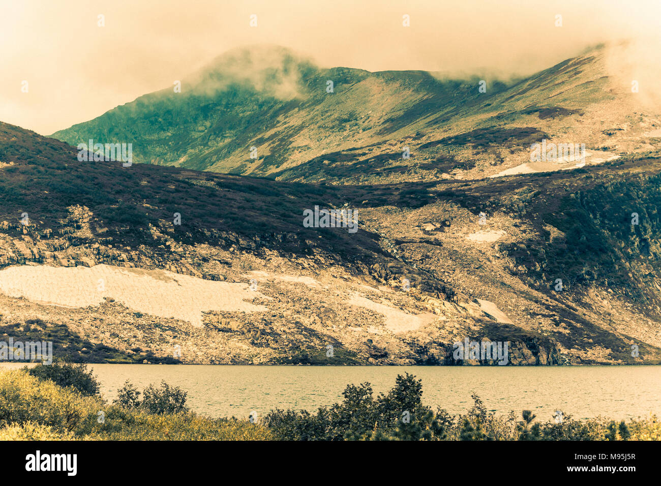 The peak view from the shore of a mountain lake. Journey through the ...