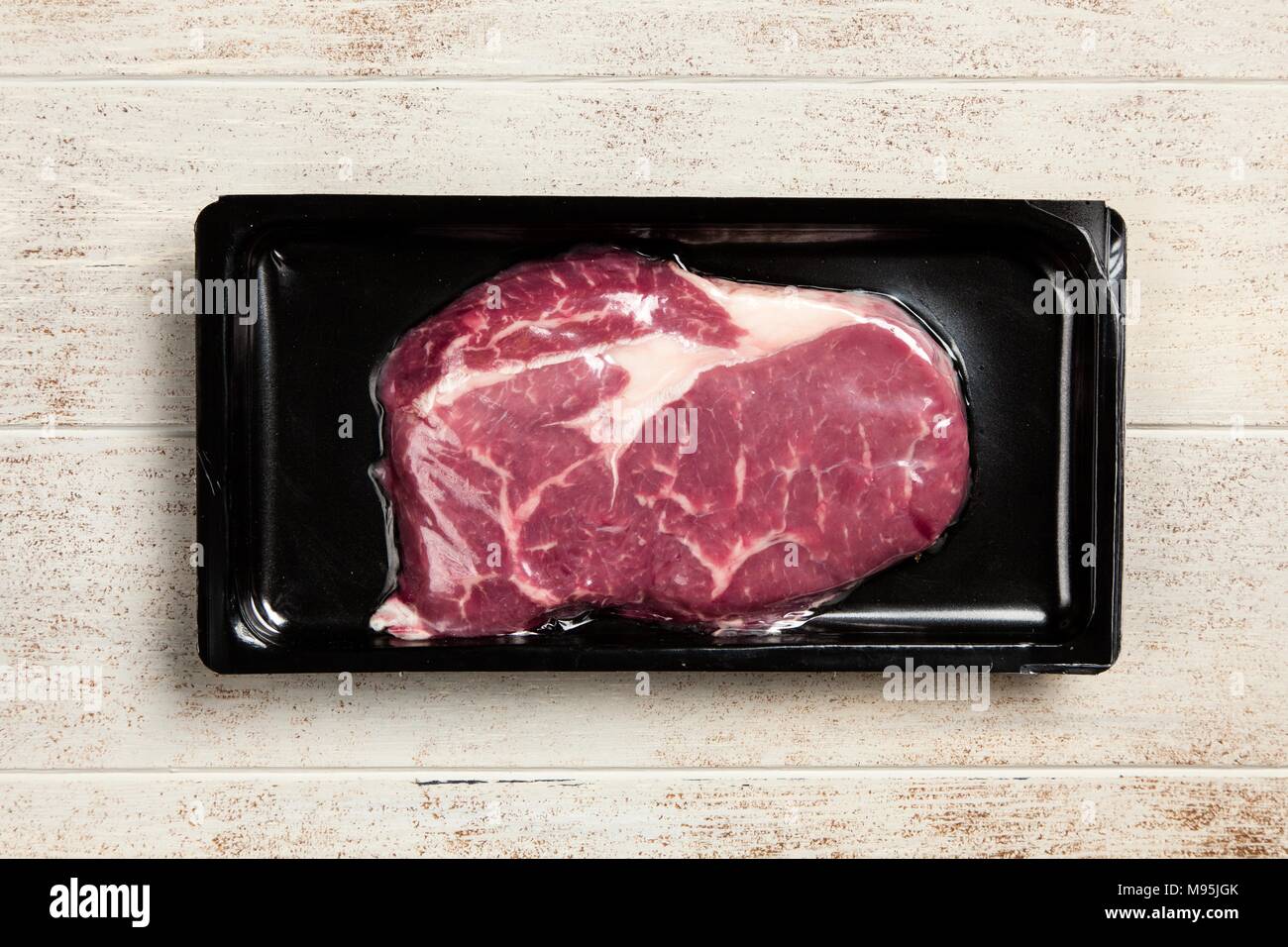 Raw steak in an airtight packaging Stock Photo - Alamy