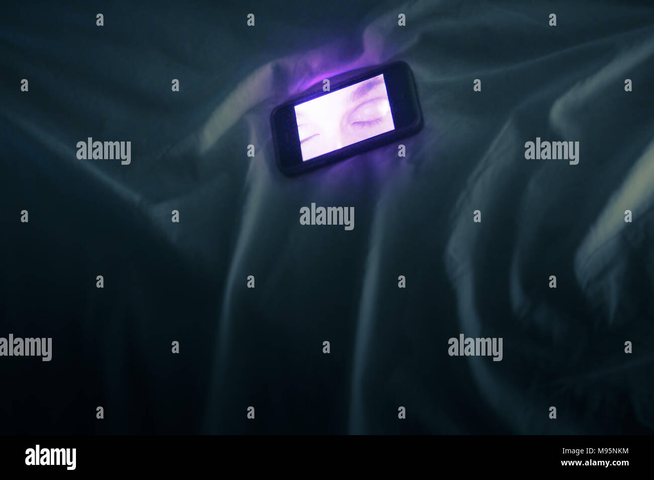 Sleep eyes on phone screen Stock Photo - Alamy