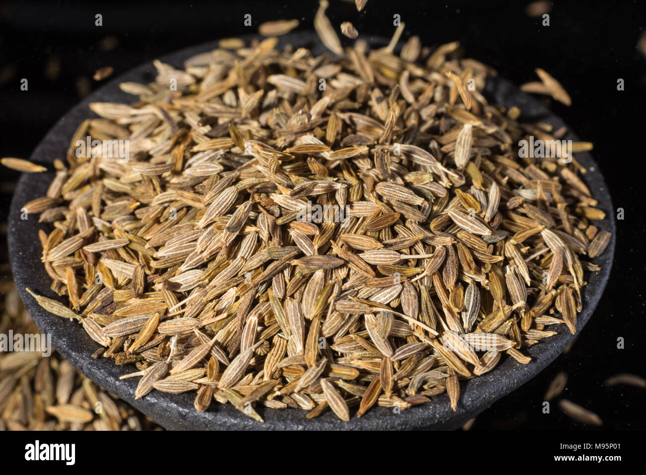 Macro collection, aromatic dried seasoning cumin close up on black ...