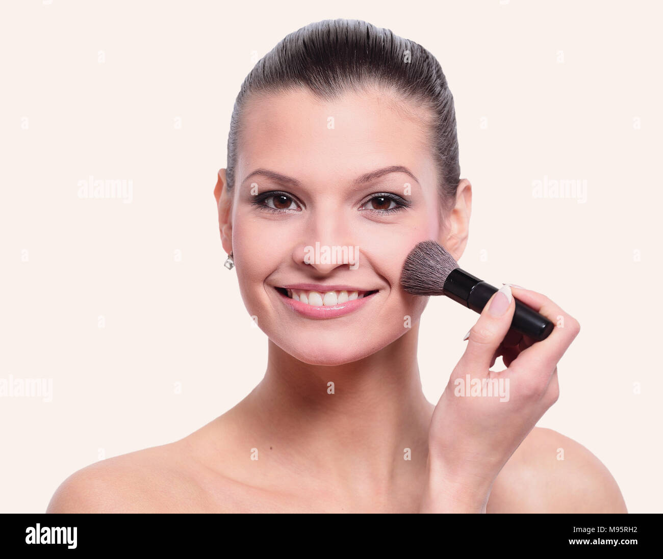 Woman applying dry cosmetic tonal foundation on the face using m Stock ...