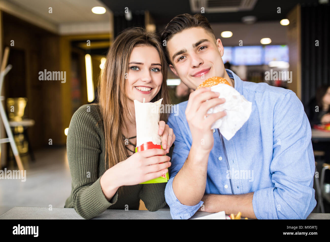 Fastfood girl man hamburger hi-res stock photography and images - Alamy