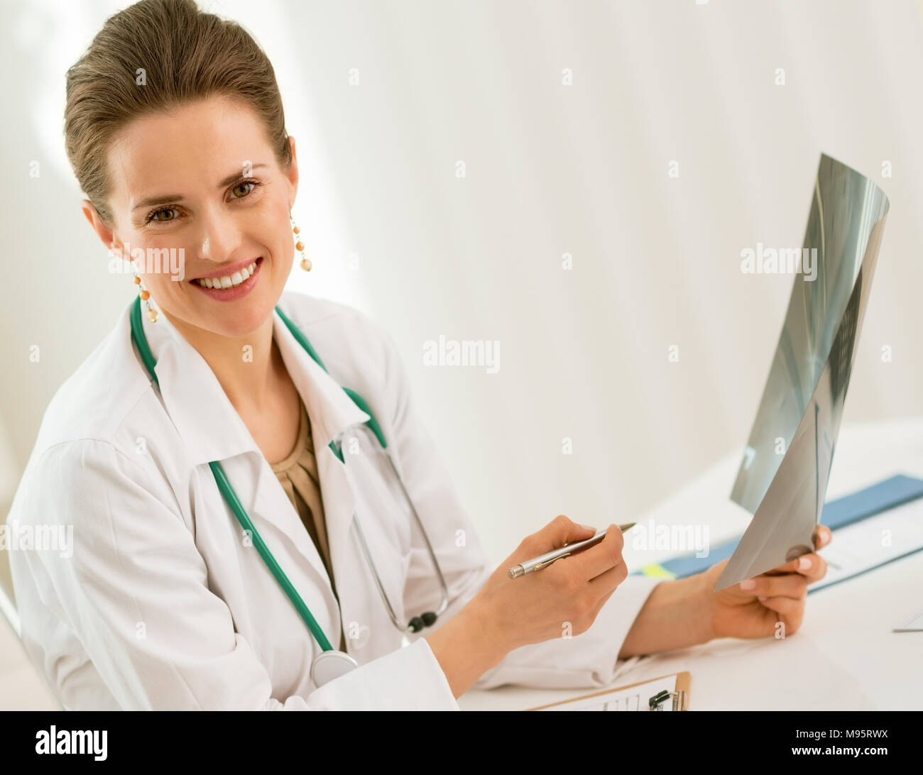 happy doctor woman holding fluorography in office Stock Photo - Alamy