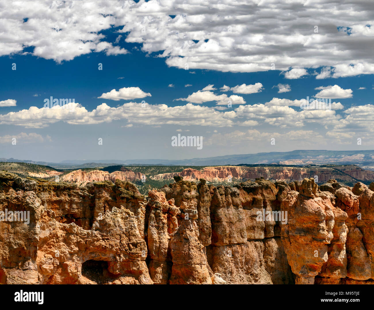 View of orange sandstone rock formations, cliffs snd steep hillsides ...