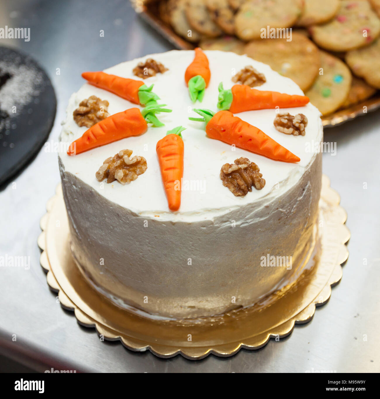 Carrot cake with cream cheese frosting and little carrots on top Stock ...