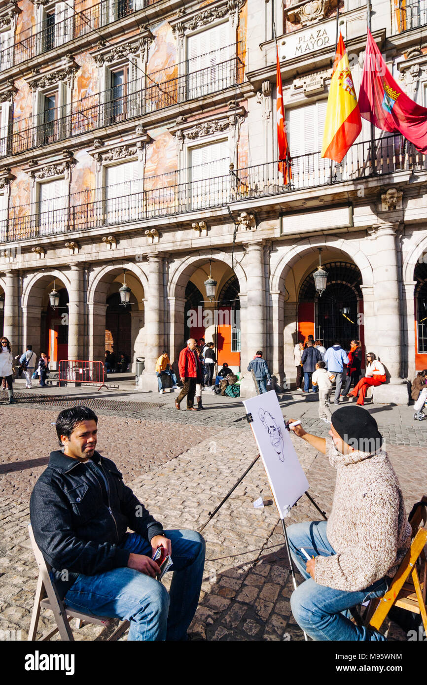 Madrid, Spain : Plaza Mayor square. A street cartoonist draws a ...