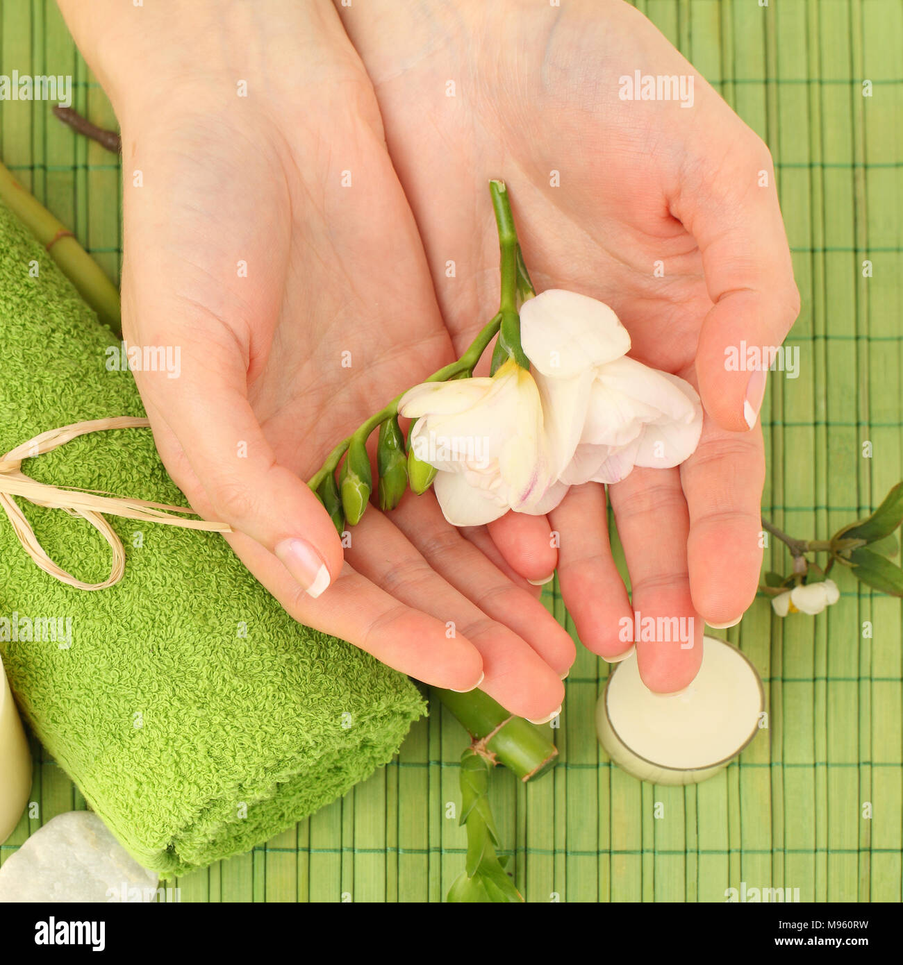 Spa manicure - hands with flower, background Stock Photo - Alamy