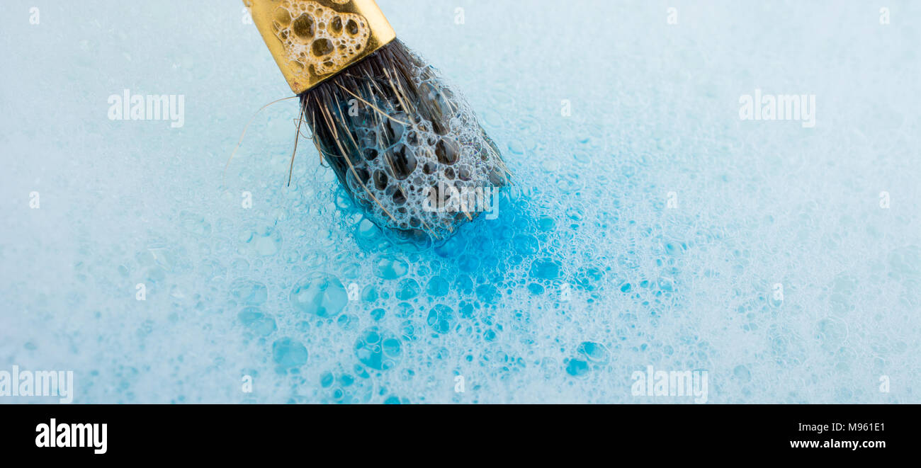 Paint dissolving in water as painting brush touching water Stock Photo ...