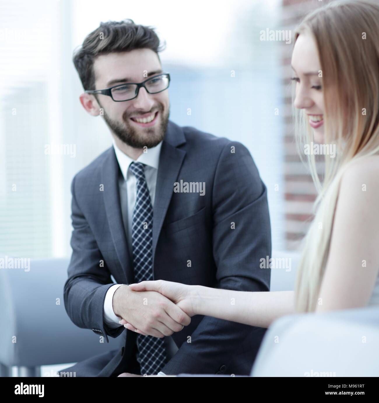 Confident woman shakes hands hi-res stock photography and images - Alamy