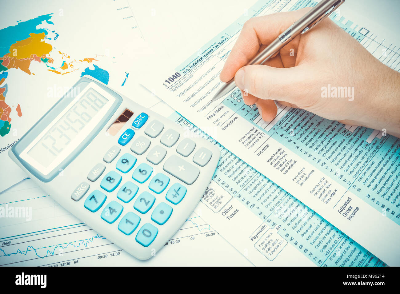 Male hand filling out 1040 US Tax Form - close up studio shot Stock ...