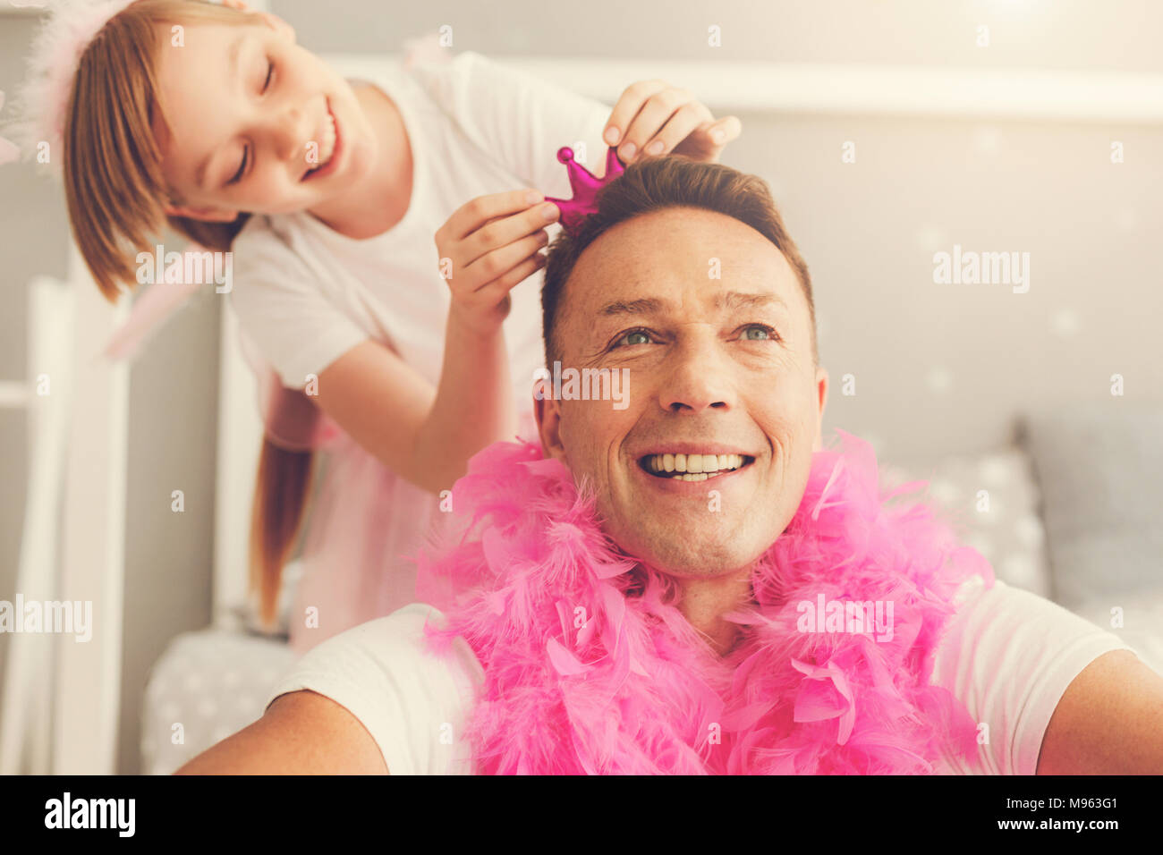 Happy nice man wearing a pink feather boa Stock Photo - Alamy
