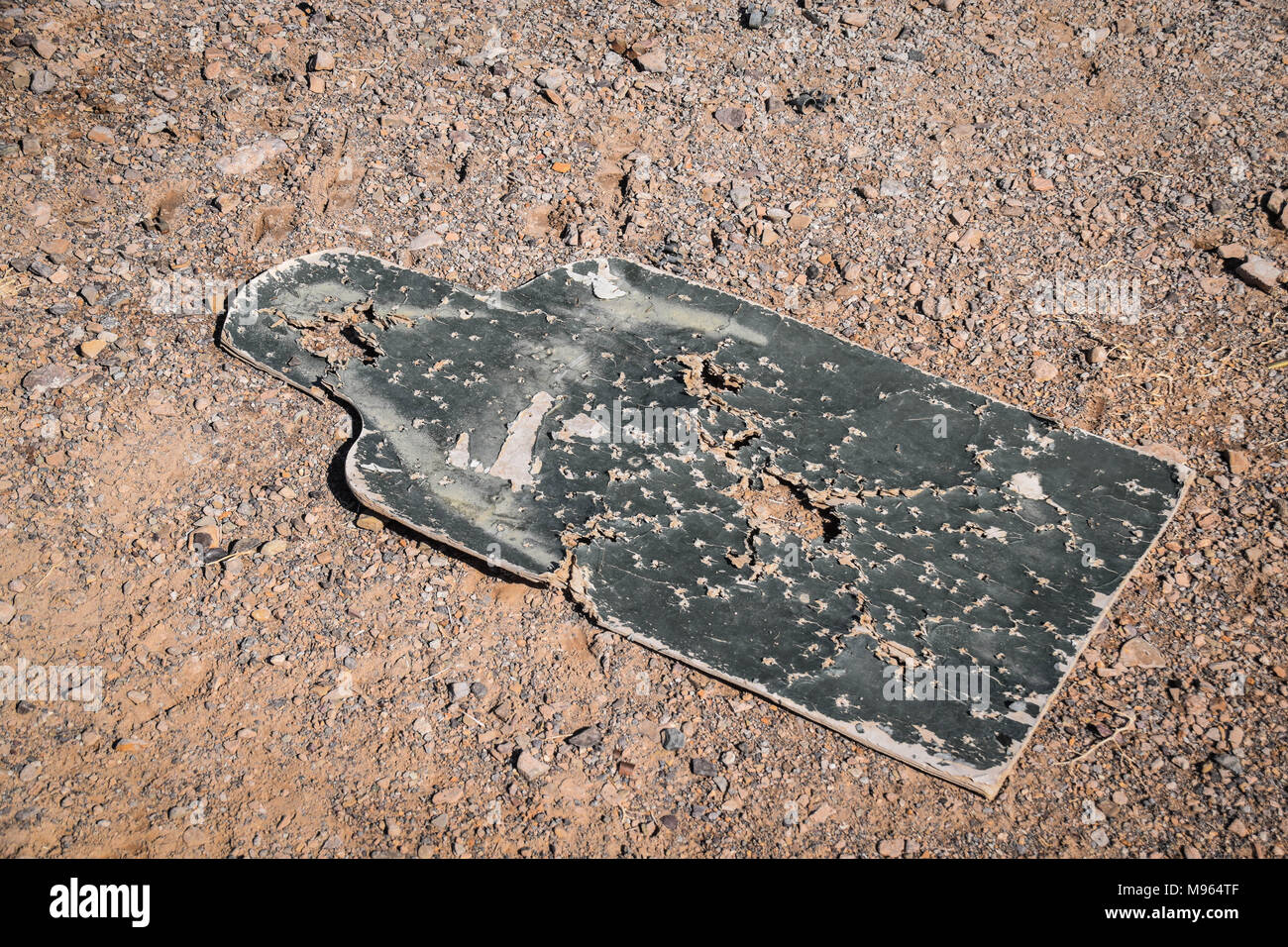 Bullet riddled target lying on the ground of a firing range just ...
