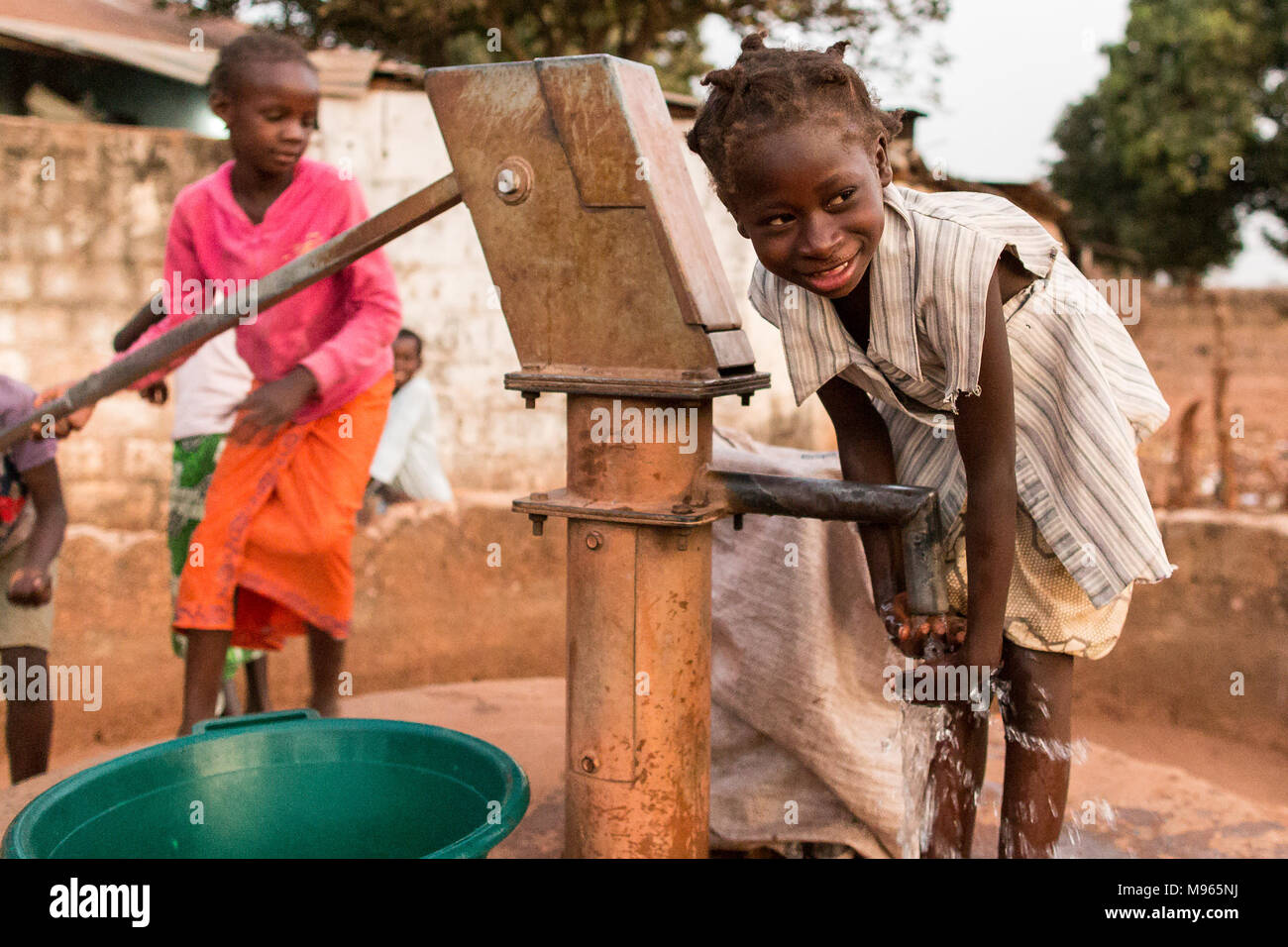 Children collect water from a local well in Besse, central Gambia Stock ...