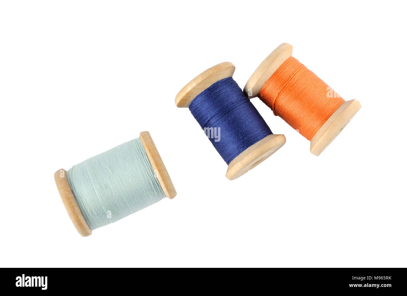 A wooden reels of thread on white background Stock Photo - Alamy