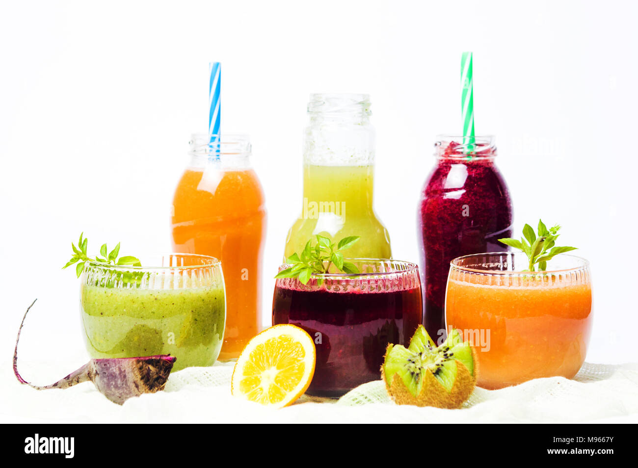 Colorful fresh juices with fruits isolated on white Stock Photo - Alamy