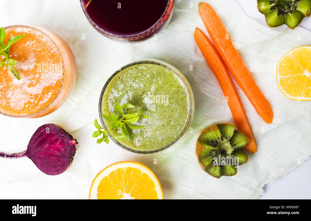 Colorful juices with ingredients on a table top view Stock Photo - Alamy