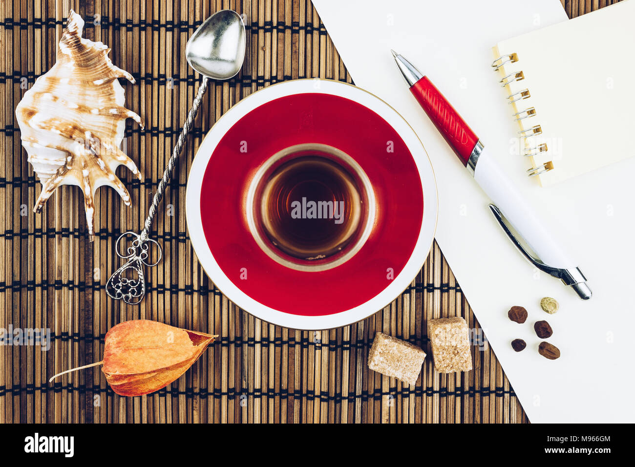 Still life red Cup of tea, spoons, shells on a wooden table Stock Photo ...