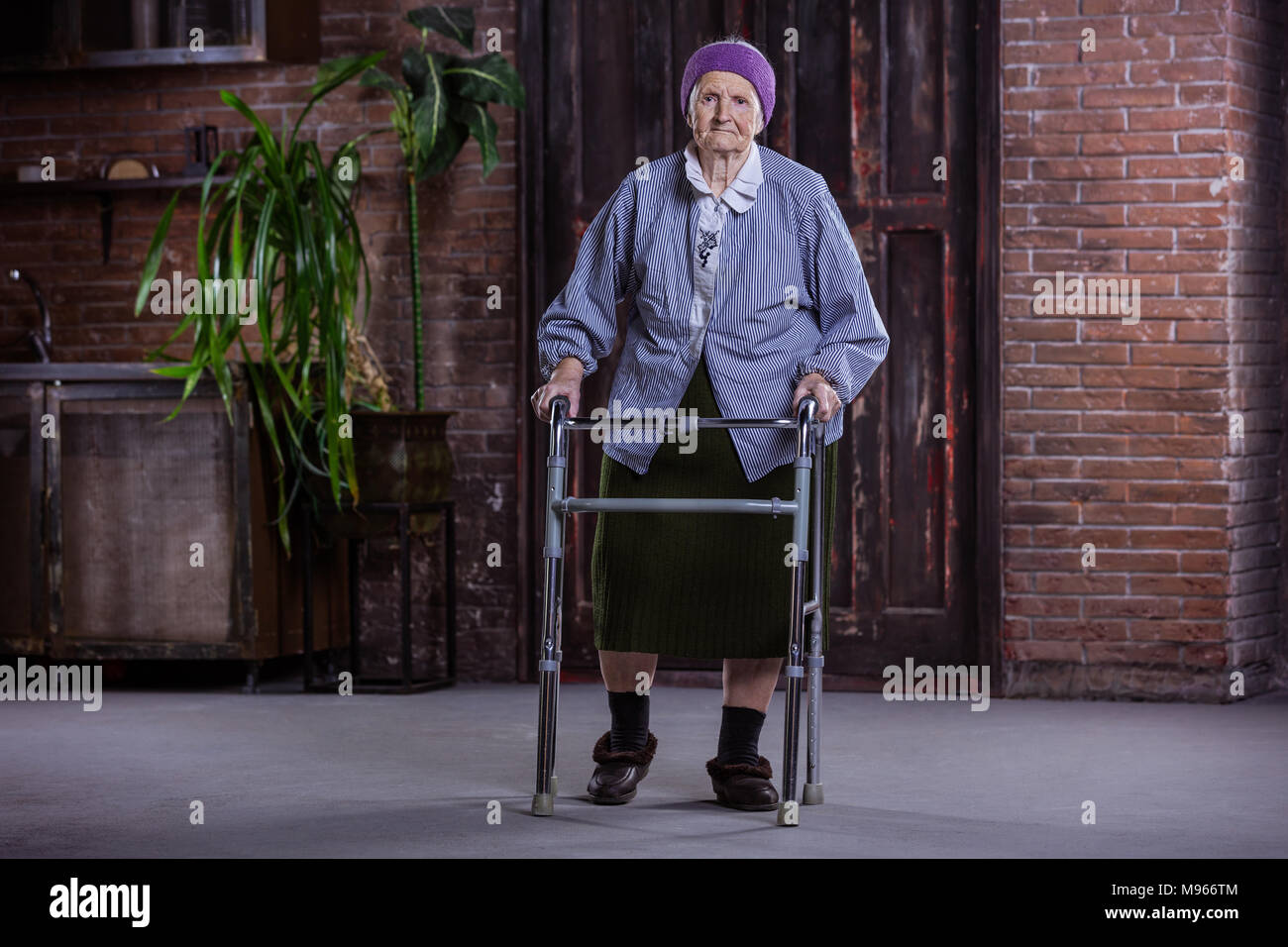 Portrait of senior woman with walker at home Stock Photo - Alamy
