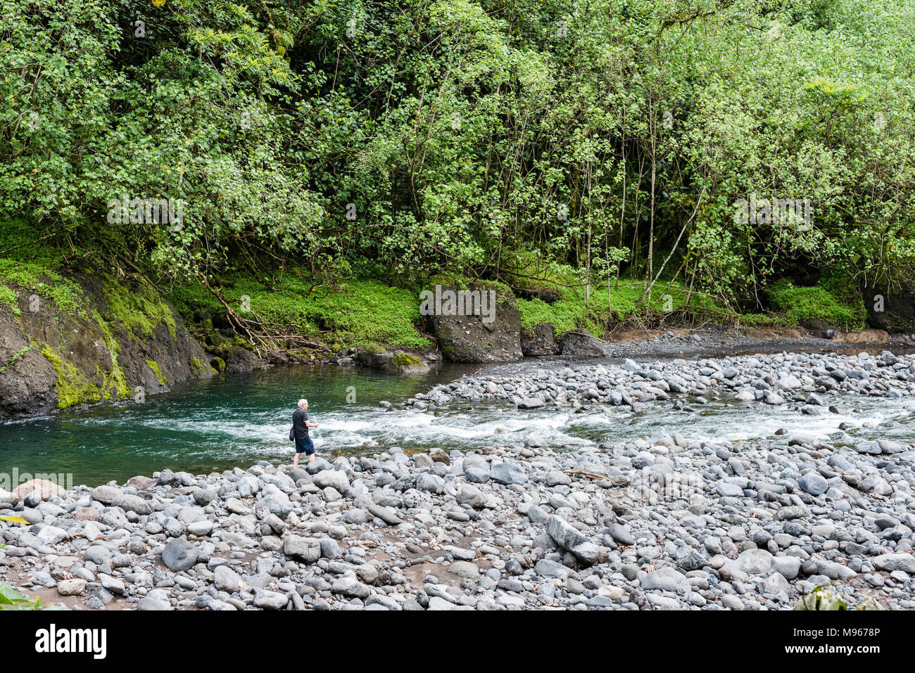Papeete, Tahiti, French Polynesia -- March 18, 2018. A tourist walks ...