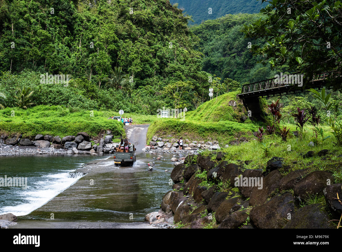 Tahiti, French Polynesia--March 18, 2018. Flatbed truck with passengers ...