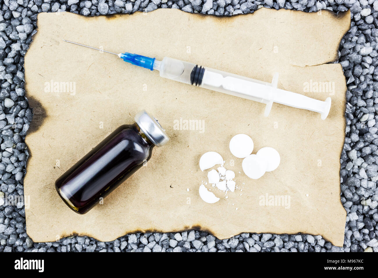 Syringe, ampoule and pills on old Kraft paper. Drug use, health care ...